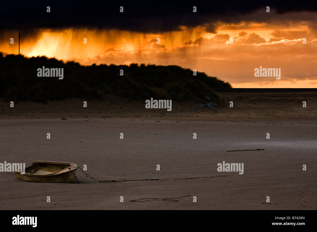 Rowing boat in the harbour before an evening storm at Barmouth Gwynedd ...