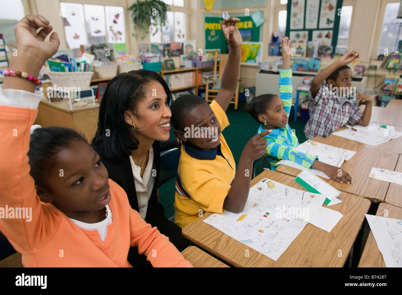 African students raising hands in classroom Stock Photo - Alamy