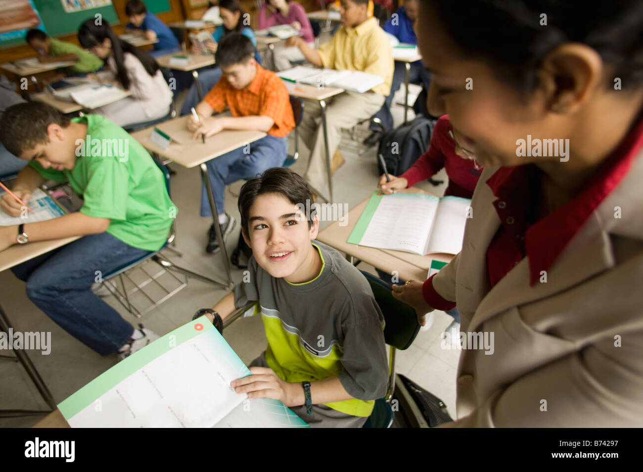 Hispanic school teacher helping student Stock Photo - Alamy