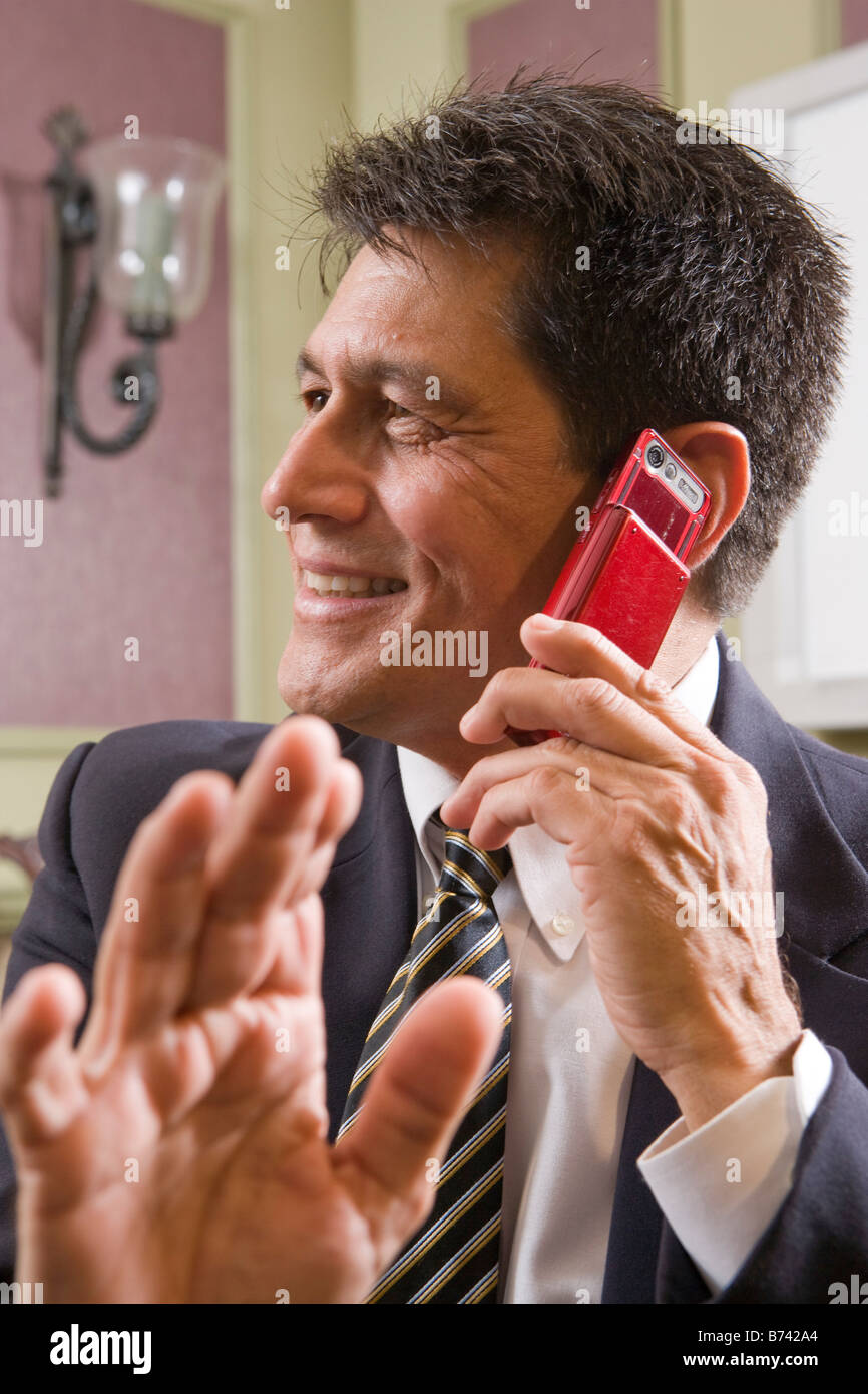 Middle-aged businessman using mobile phone, gesturing Stock Photo - Alamy