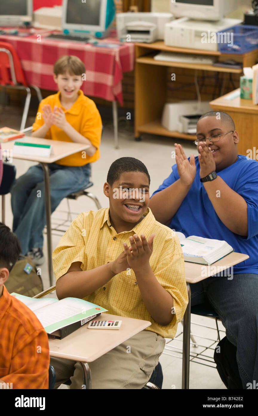 Students clapping in classroom Stock Photo - Alamy