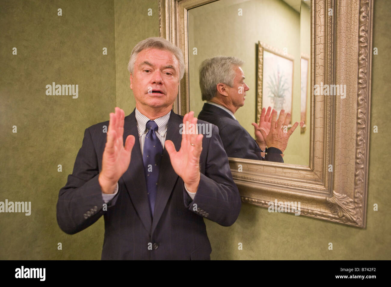 Portrait of middle-aged businessman explaining directly Stock Photo - Alamy