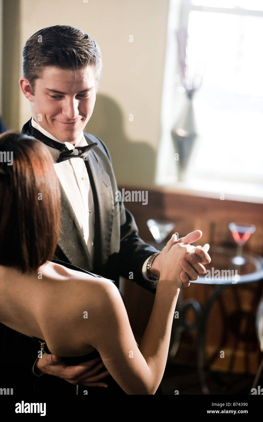 Young adult couple dressed in formal attire dancing in a club Stock ...