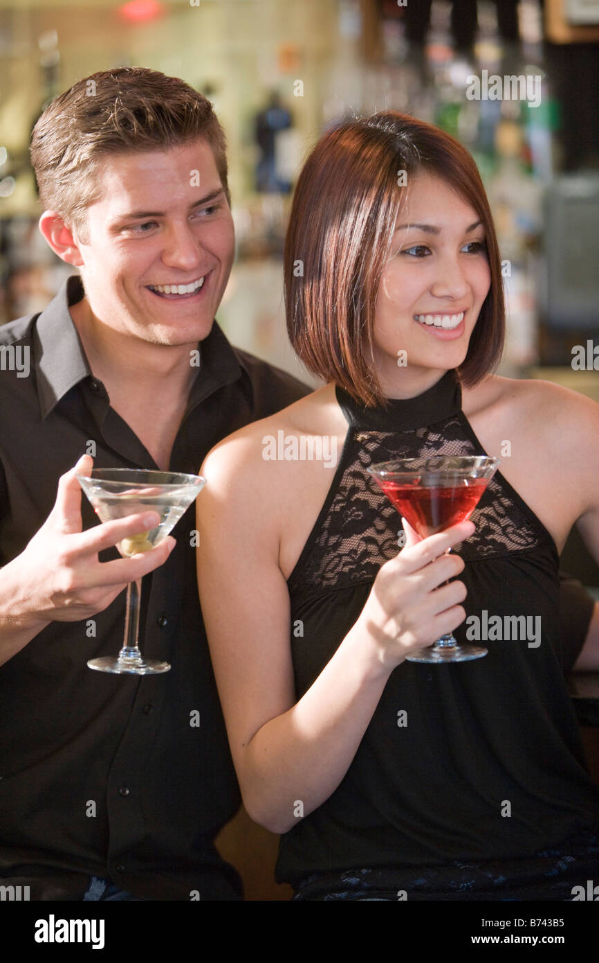 Young couple enjoying cocktails together Stock Photo - Alamy