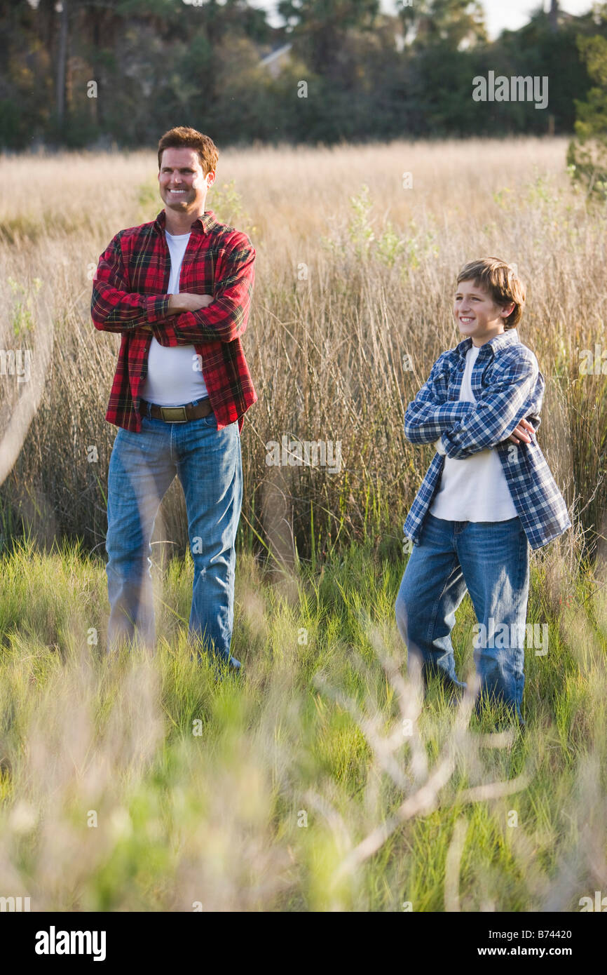 Son and father standing in grass in outdoor clothing Stock Photo - Alamy