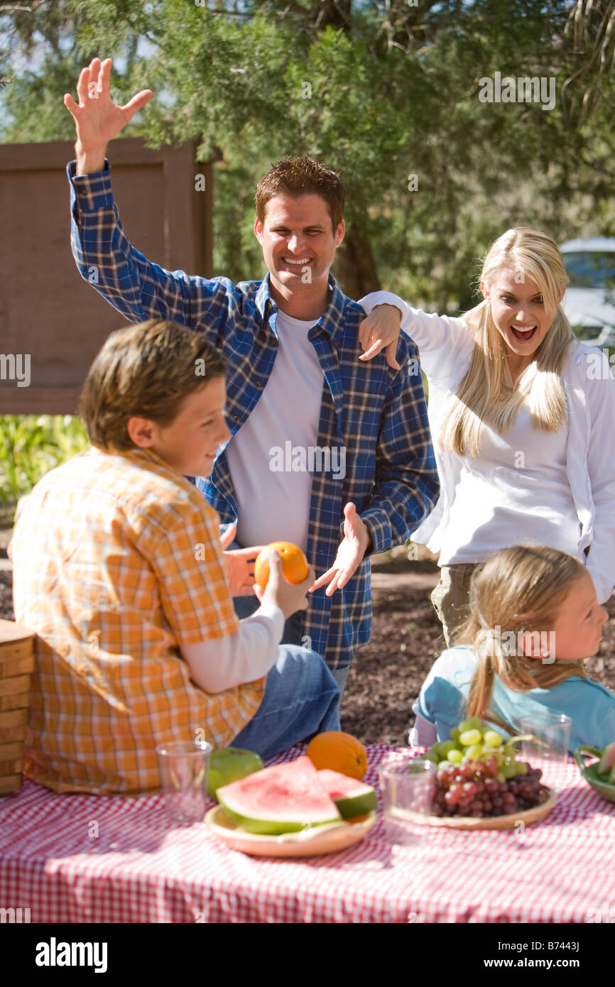 Family having fun at picnic table Stock Photo - Alamy