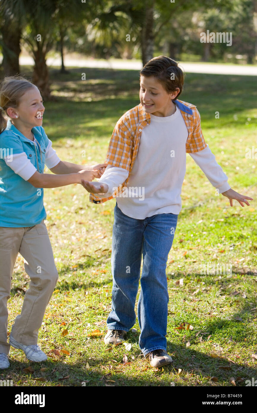 Two children playing and running together in park Stock Photo - Alamy