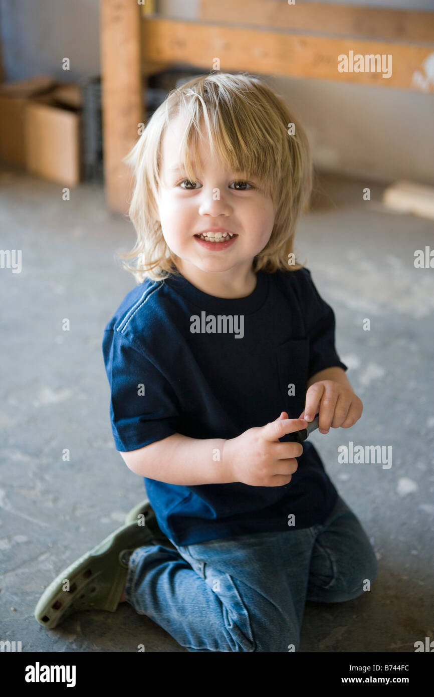Boy kneeling on floor hi-res stock photography and images - Alamy