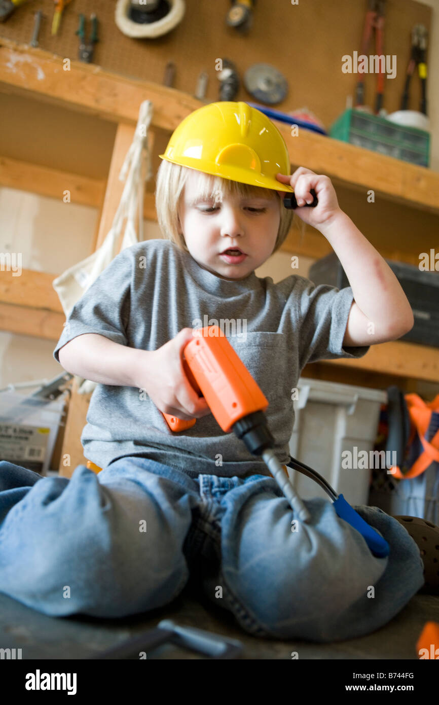 Little boy playing with toy tools Stock Photo - Alamy
