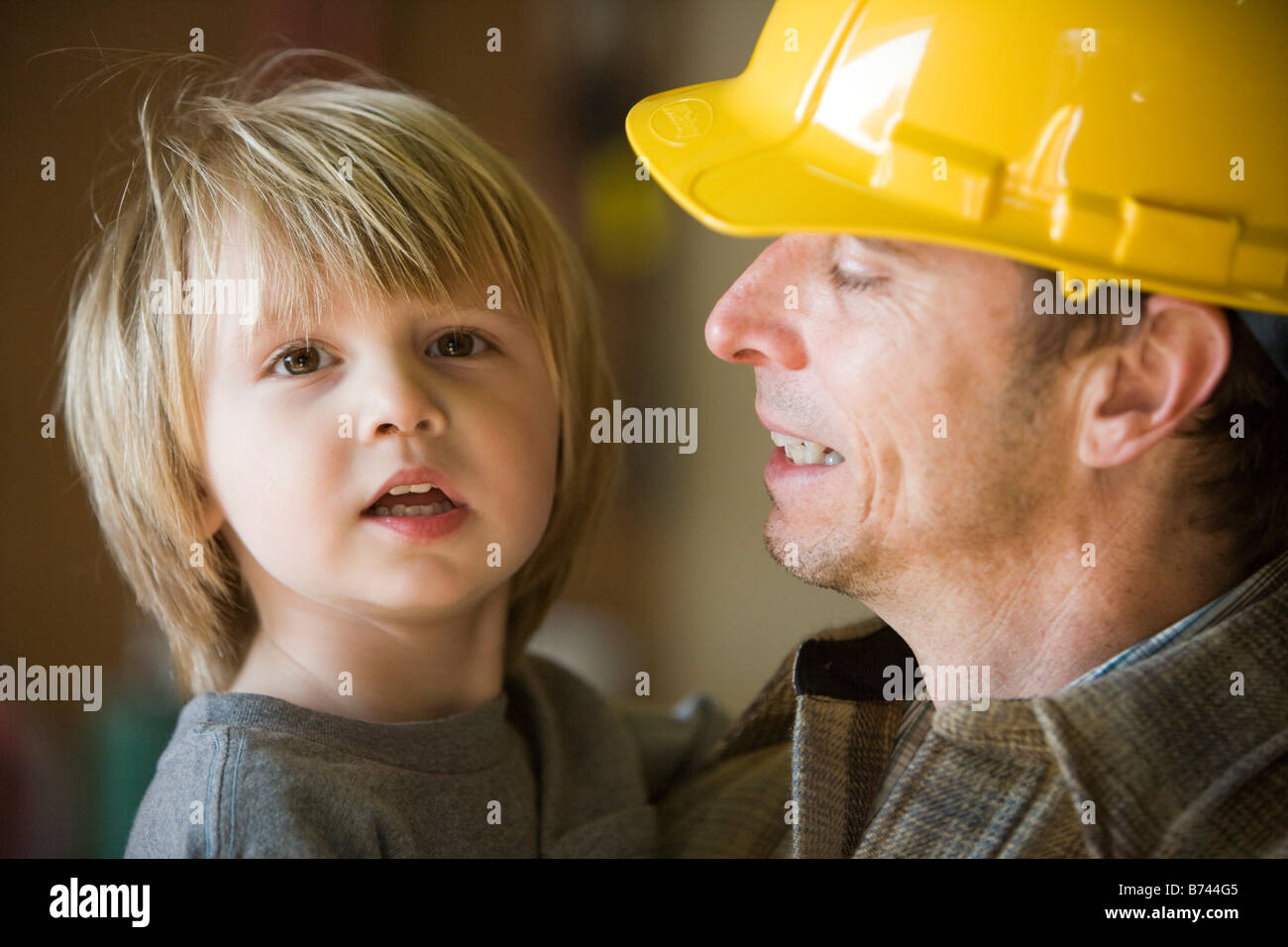Portrait of father and son wearing hard hats Stock Photo - Alamy