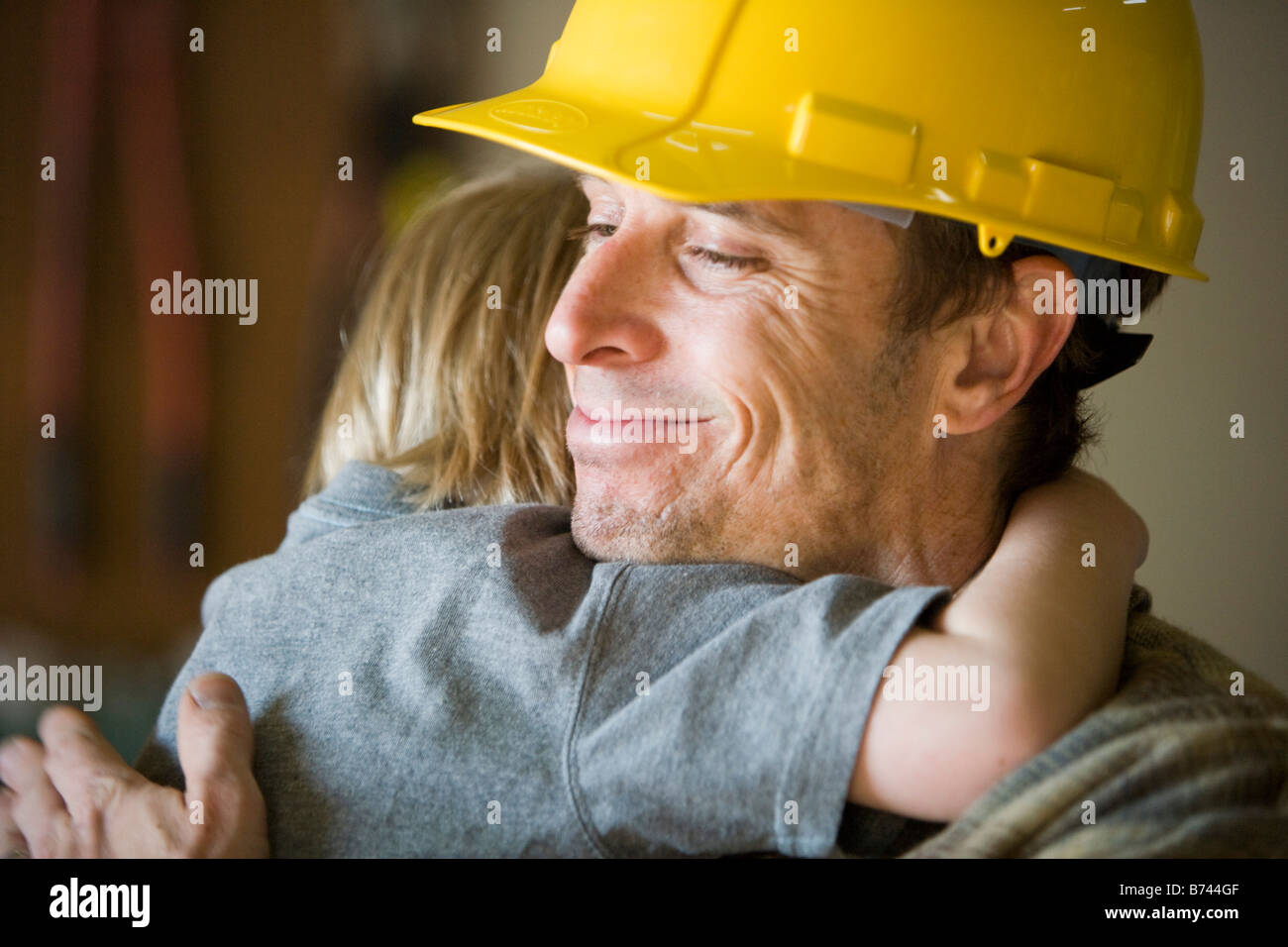 Portrait of father in hard hat hugging son Stock Photo - Alamy