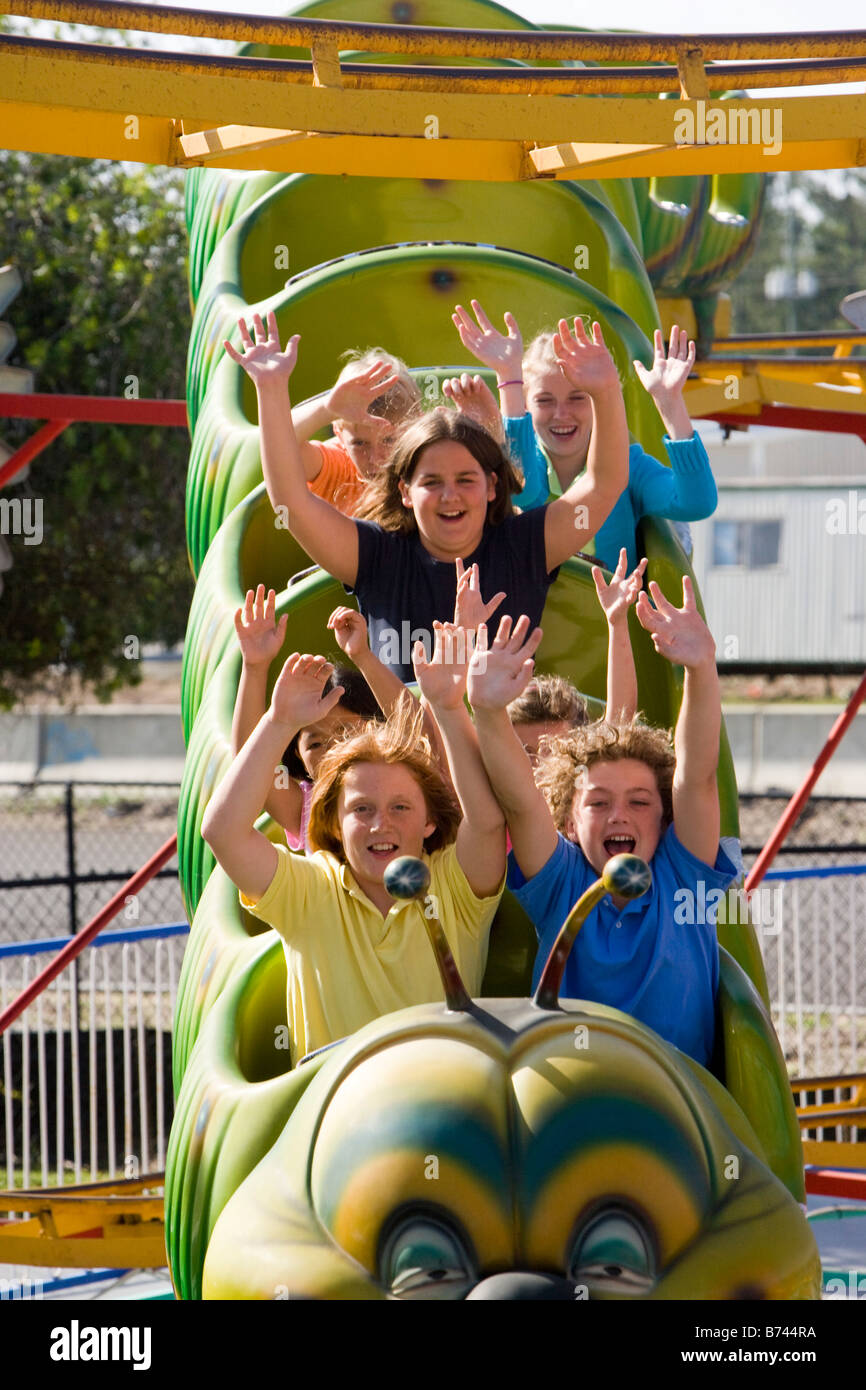 Children riding a roller coaster in an amusement park Stock Photo - Alamy