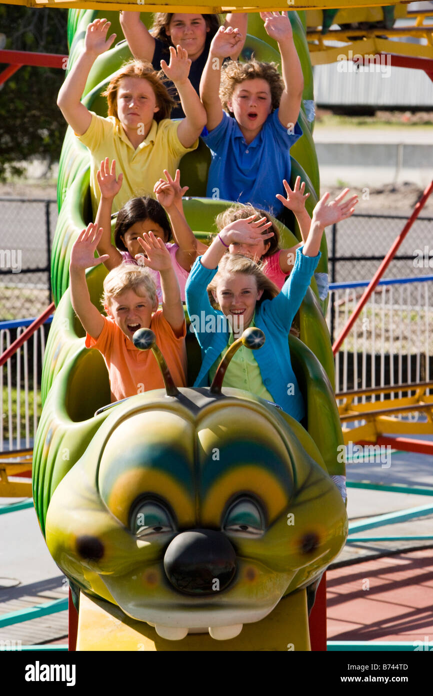 Children riding a roller coaster in an amusement park Stock Photo - Alamy