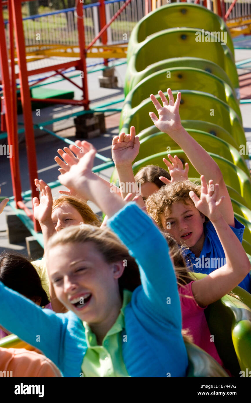 Children riding a roller coaster in an amusement park Stock Photo - Alamy