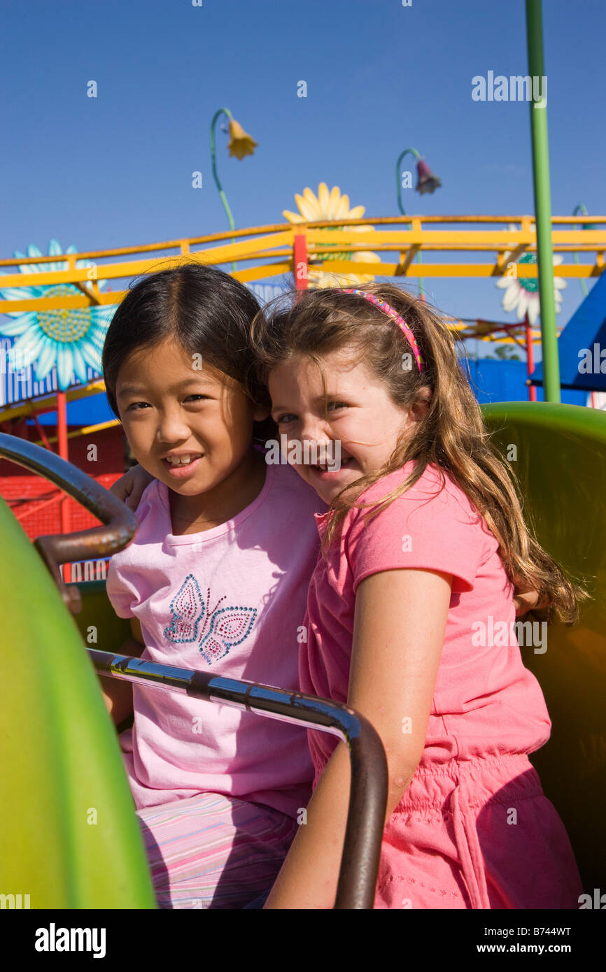 Children riding a roller coaster in an amusement park Stock Photo - Alamy
