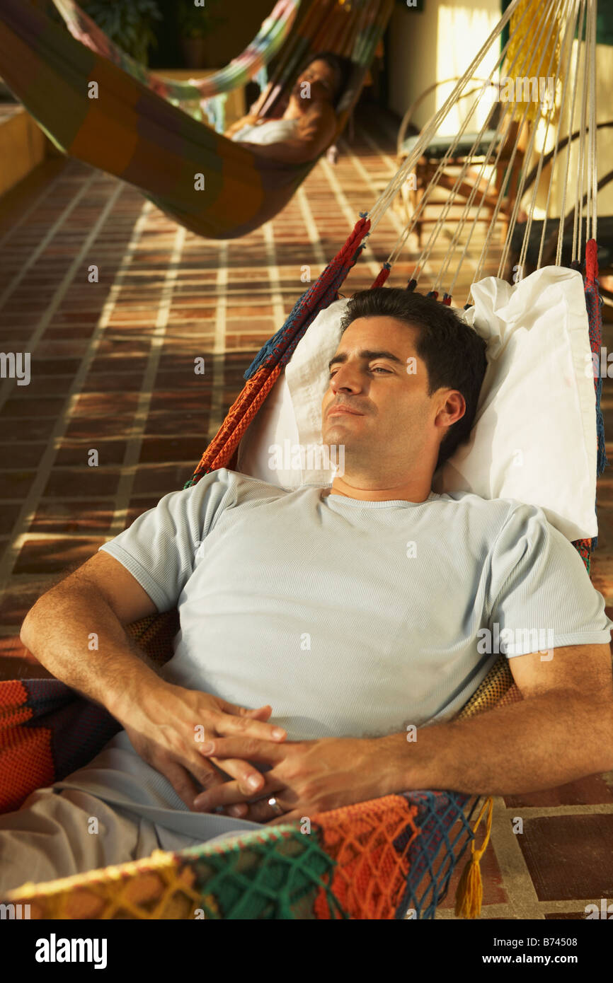 Man laying in hammock Stock Photo - Alamy