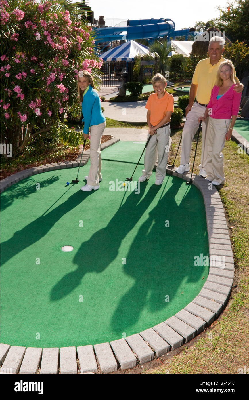 Family playing miniature golf Stock Photo - Alamy