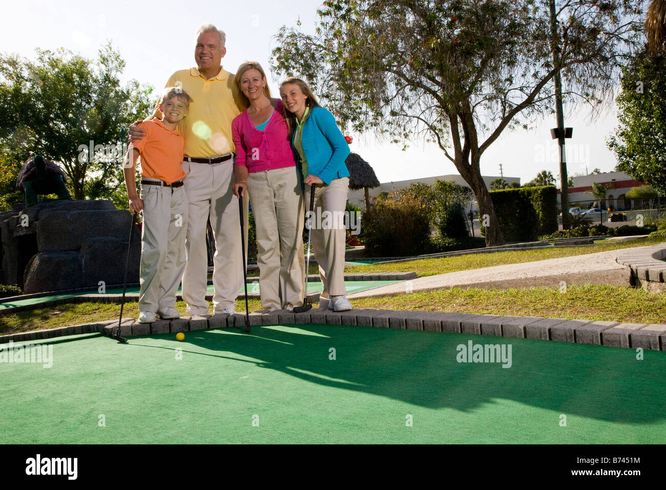 Family playing miniature golf Stock Photo - Alamy