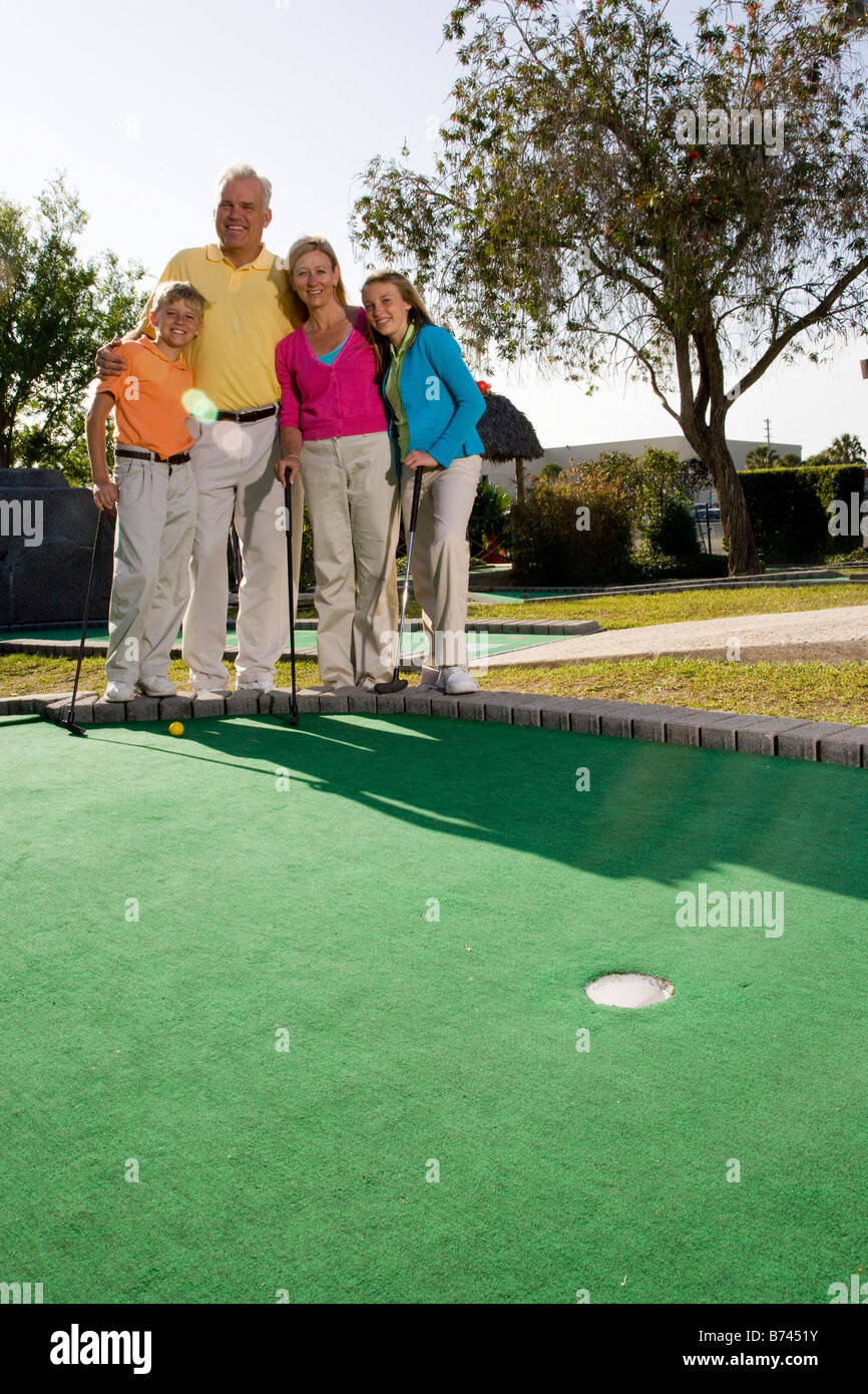 Family playing miniature golf Stock Photo - Alamy
