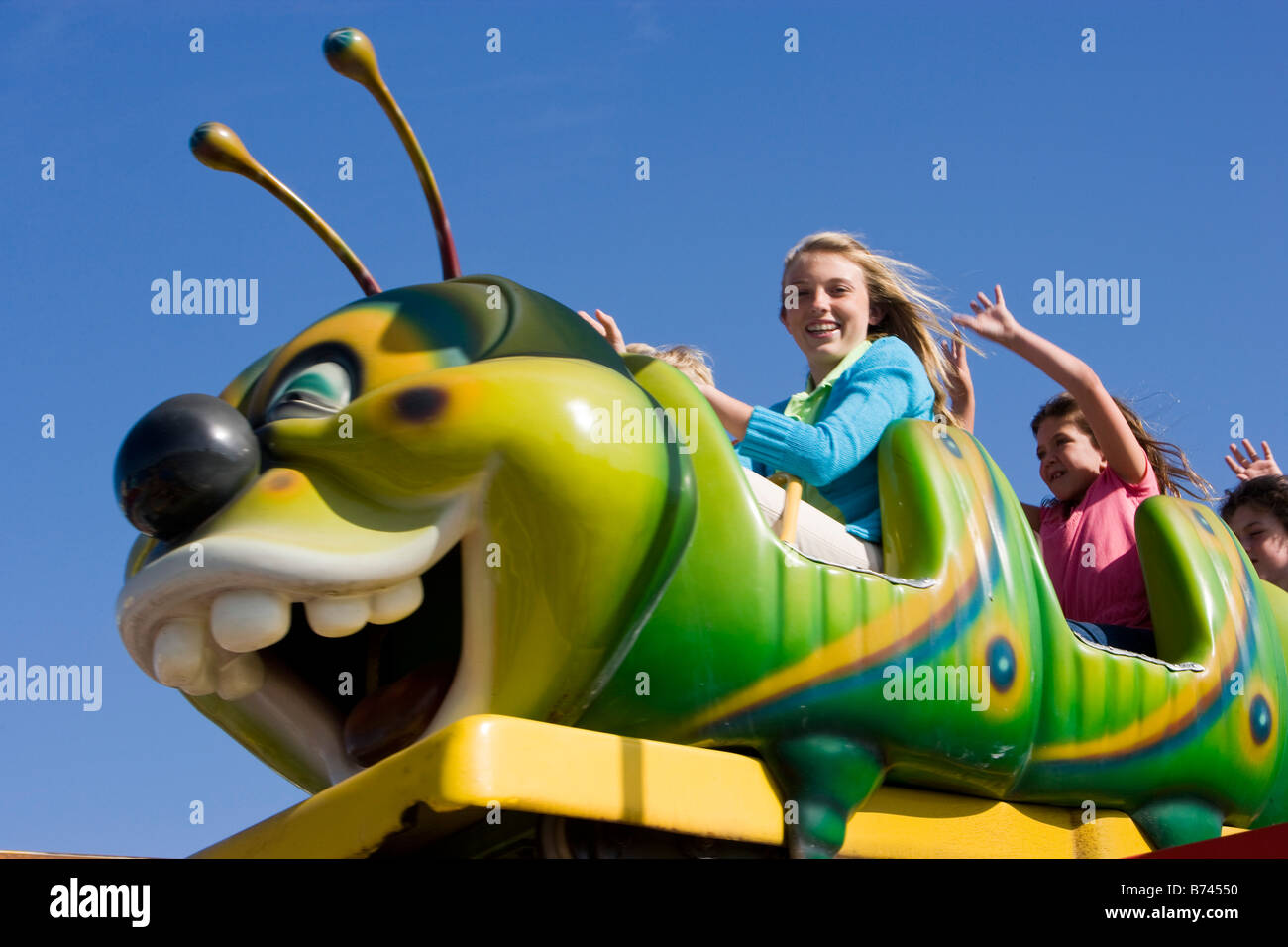 Children riding a rollercoaster at amusement park Stock Photo - Alamy