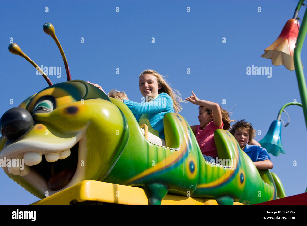 Children riding a rollercoaster at amusement park Stock Photo - Alamy