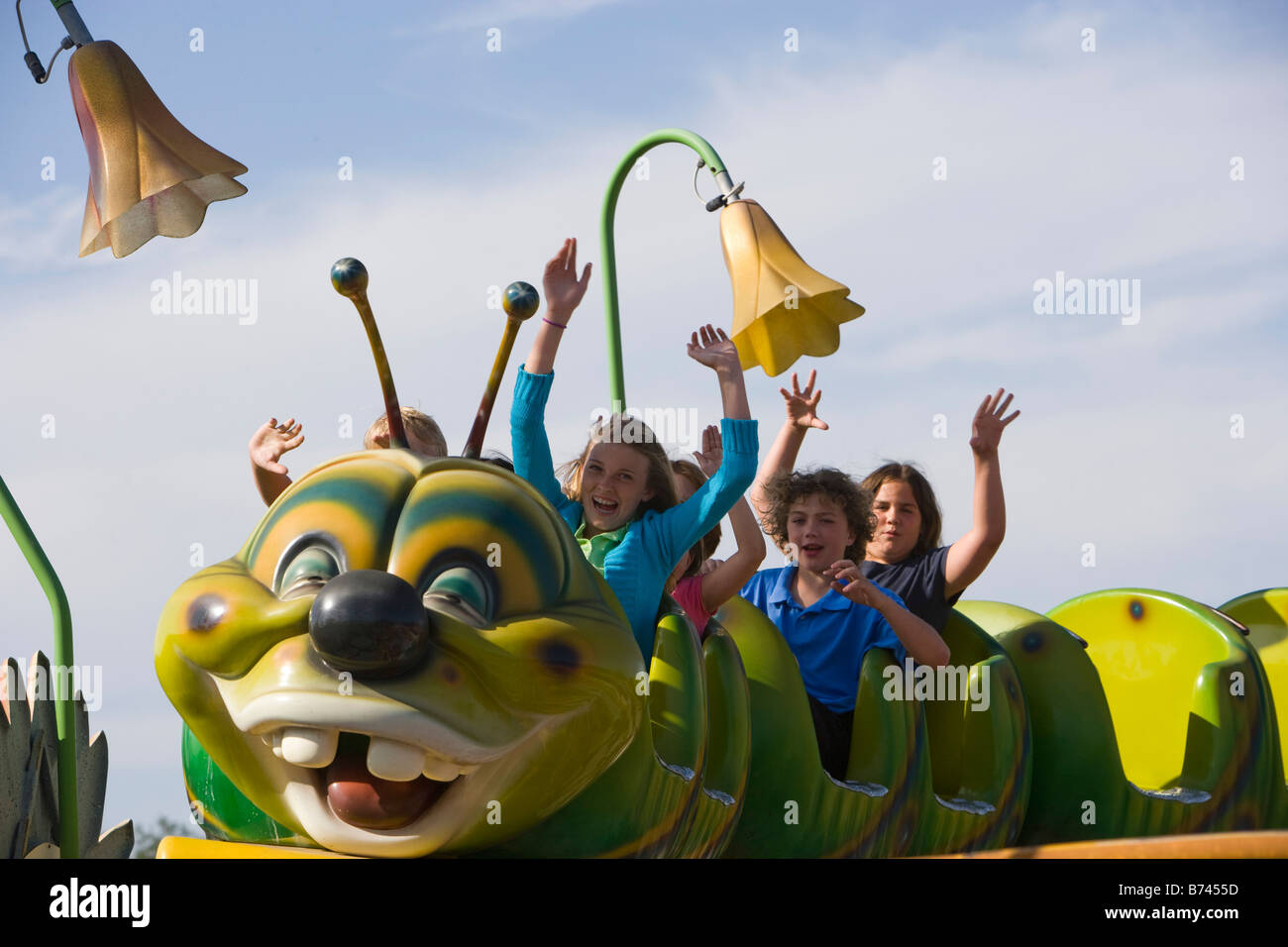 Children riding a rollercoaster at amusement park Stock Photo - Alamy