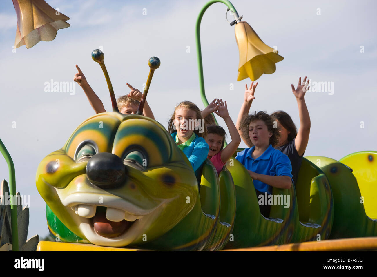 Children riding a rollercoaster at amusement park Stock Photo - Alamy