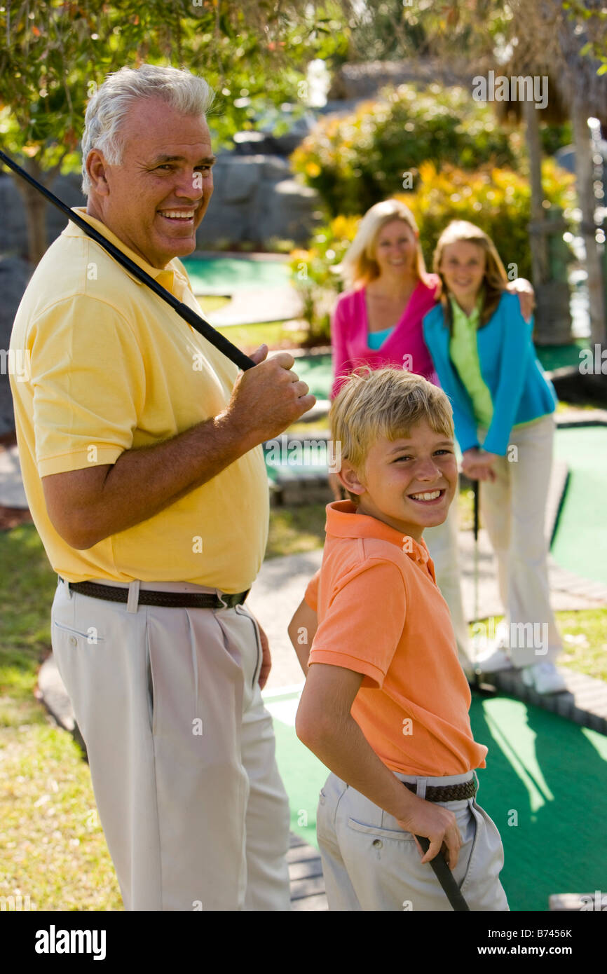 Family playing miniature golf Stock Photo - Alamy
