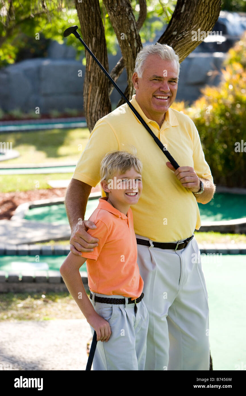 Father and son playing miniature golf Stock Photo - Alamy