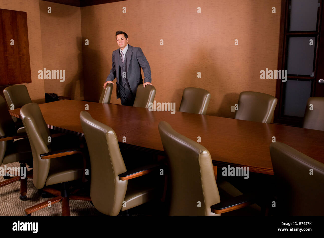 Businessman standing in conference room Stock Photo - Alamy