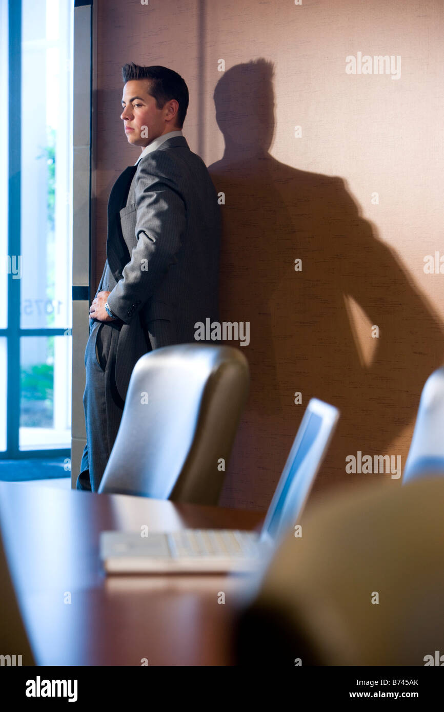 Businessman standing conference room by window Stock Photo - Alamy