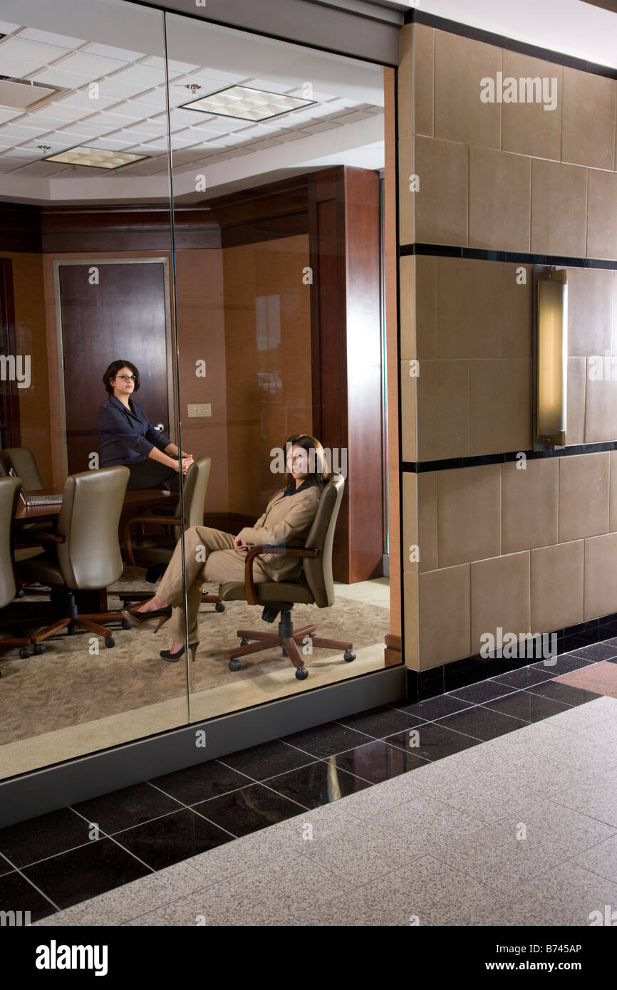 Two diverse businesswomen sitting table hi-res stock photography and ...