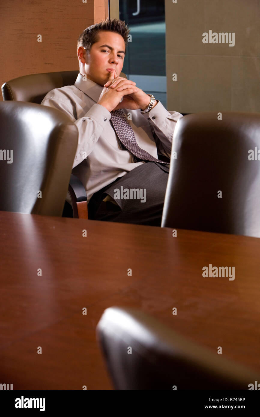 Businessman sitting in conference room Stock Photo - Alamy