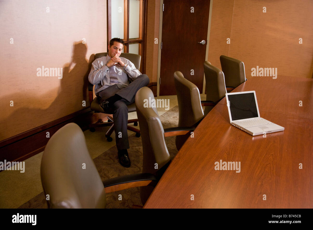 Businessman sitting in conference room Stock Photo - Alamy