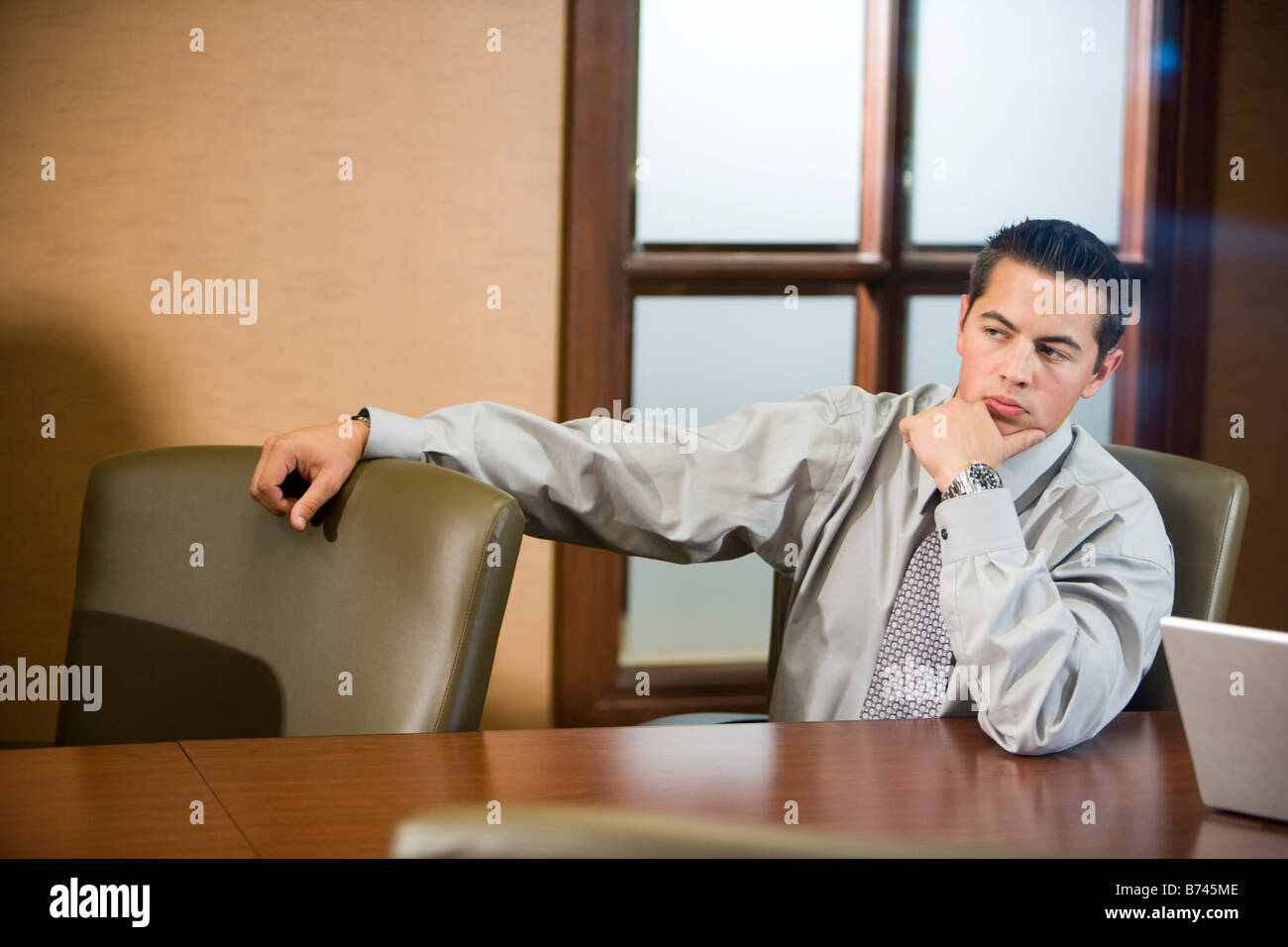 Profile of young businessman thinking in conference room Stock Photo ...