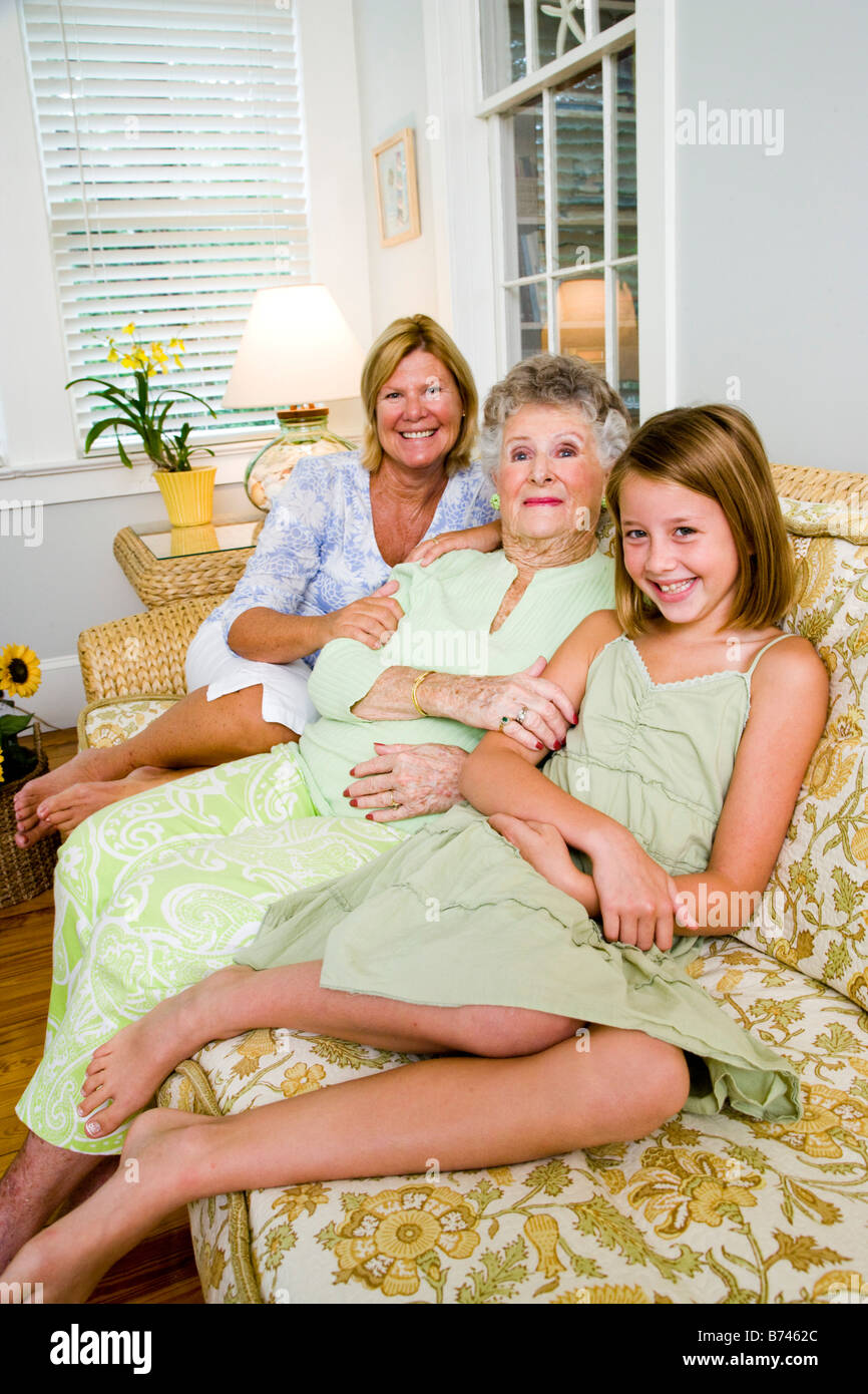 Portrait of three generation family relaxing in living room Stock Photo ...