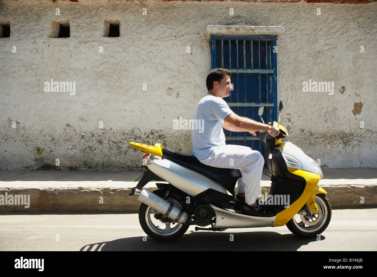 Man riding scooter Stock Photo - Alamy