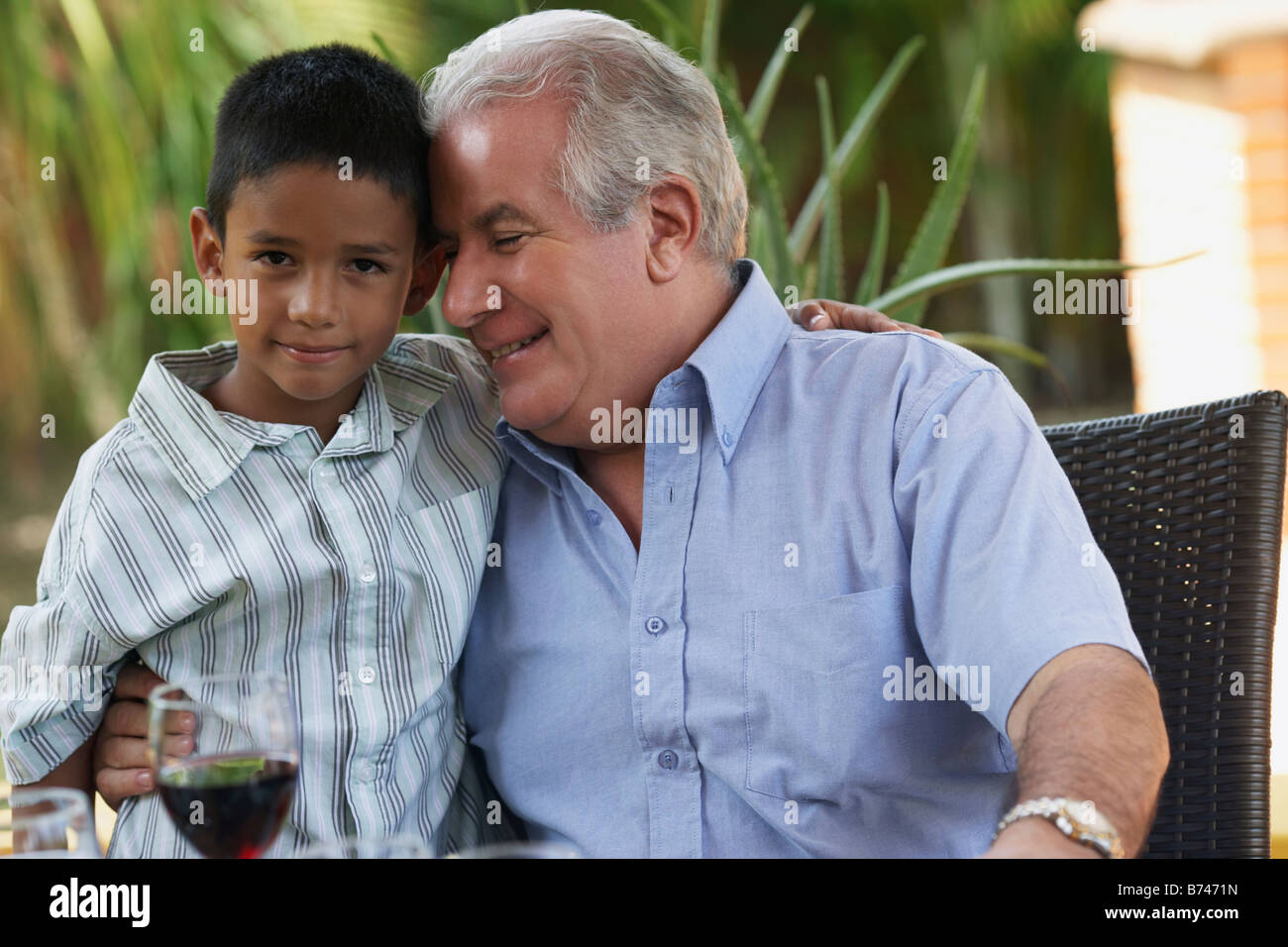 Hispanic grandfather hugging grandson Stock Photo - Alamy