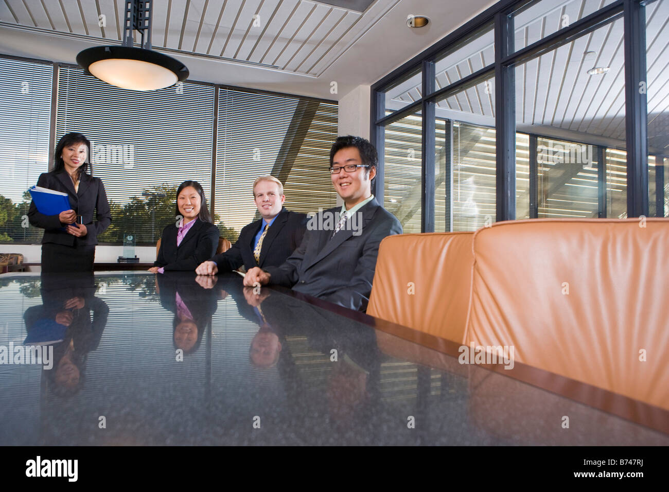 Caucasian businessman meeting with group of Asian executives Stock ...