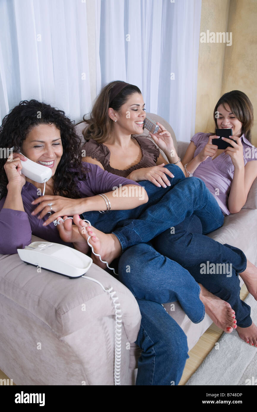 Multi-generational women using different phones Stock Photo - Alamy