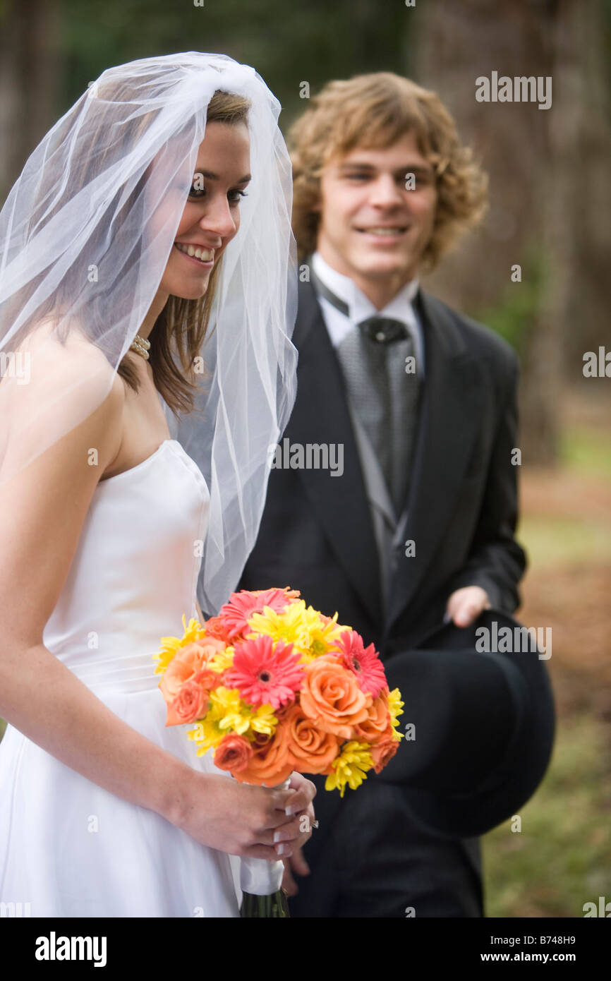 Young bride and groom standing outside on wedding day Stock Photo - Alamy