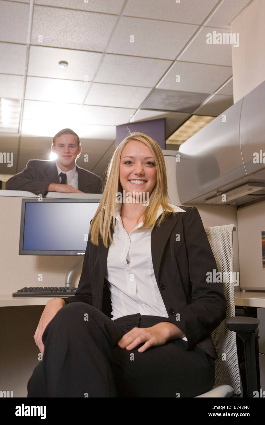 Two happy young office workers in cubicle Stock Photo - Alamy