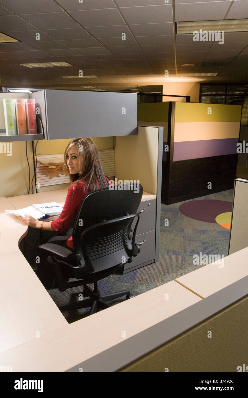 Young female office worker sitting at office cubicle Stock Photo - Alamy
