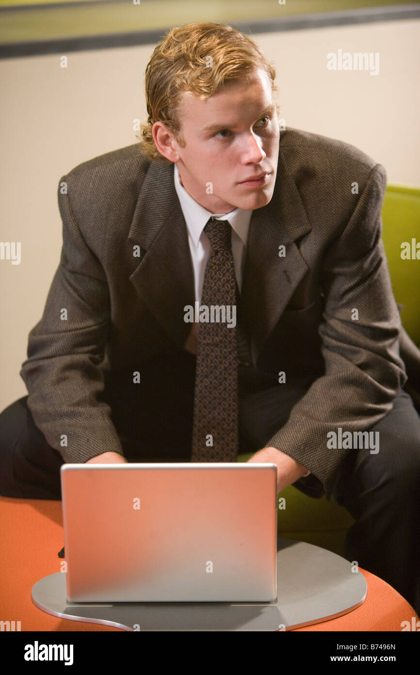 Young male office worker using laptop in office Stock Photo - Alamy