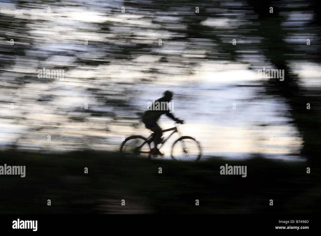 person riding fast bike on rural lane countryside Stock Photo - Alamy