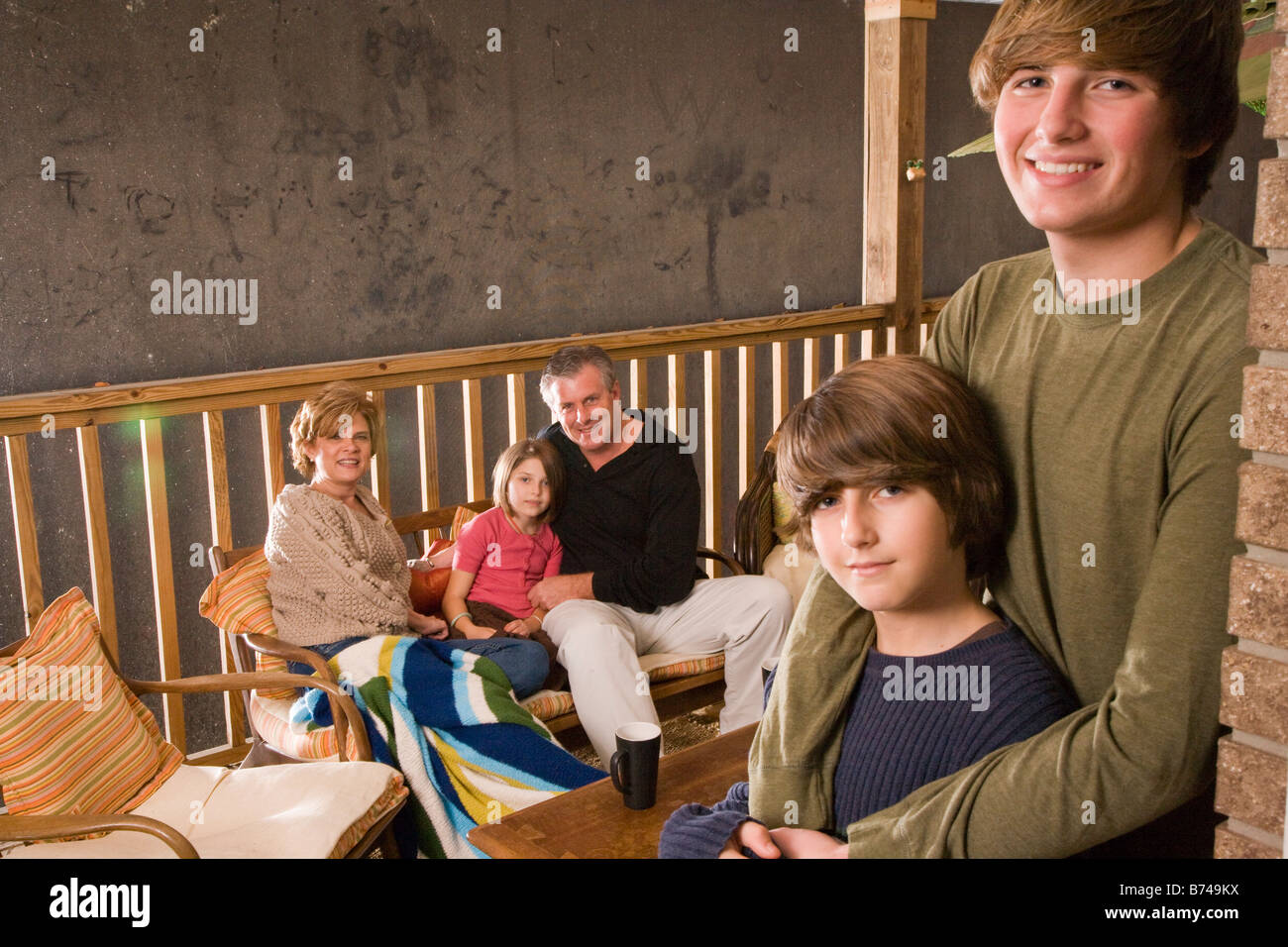 Two brothers with family in background Stock Photo - Alamy