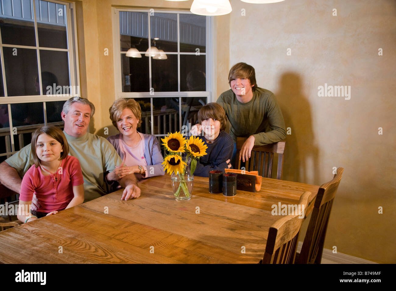 Portrait of family together hanging out in dining room Stock Photo - Alamy
