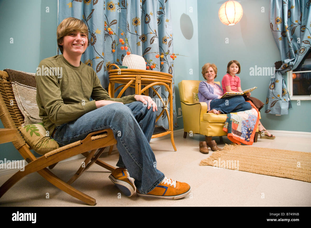 Portrait of family sitting together in living room Stock Photo - Alamy