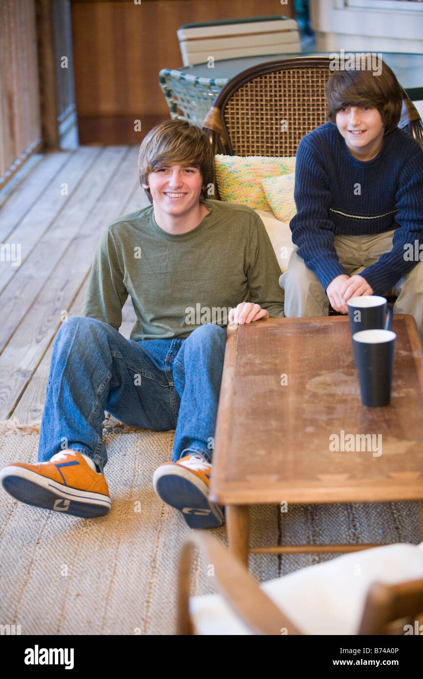 Portrait of brothers sitting together on back porch Stock Photo - Alamy