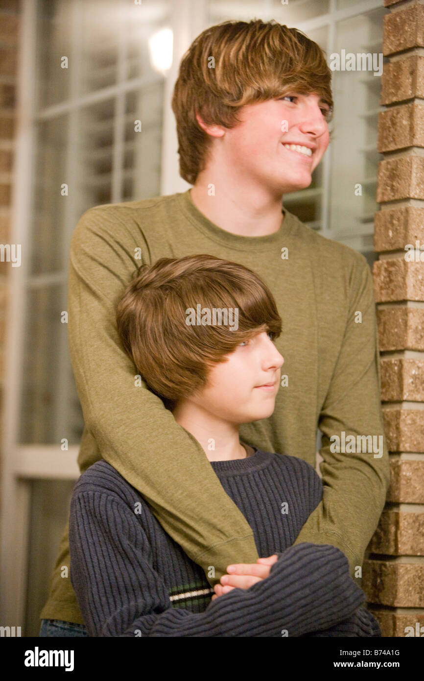 Portrait of brothers standing beside house, outdoors Stock Photo - Alamy